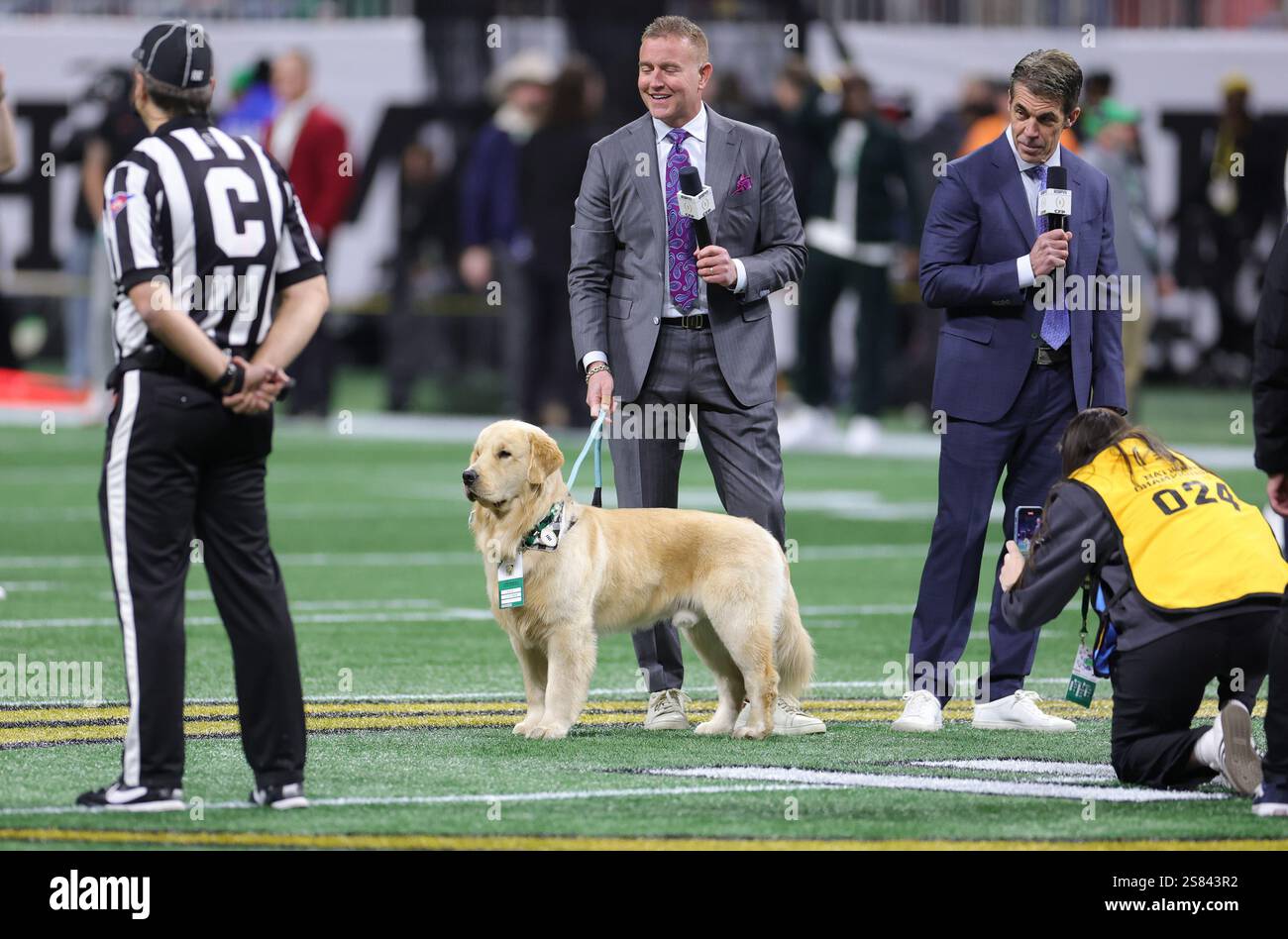 ESPN commentator Kirk Herbstreit holds his dog Peter before the start ...