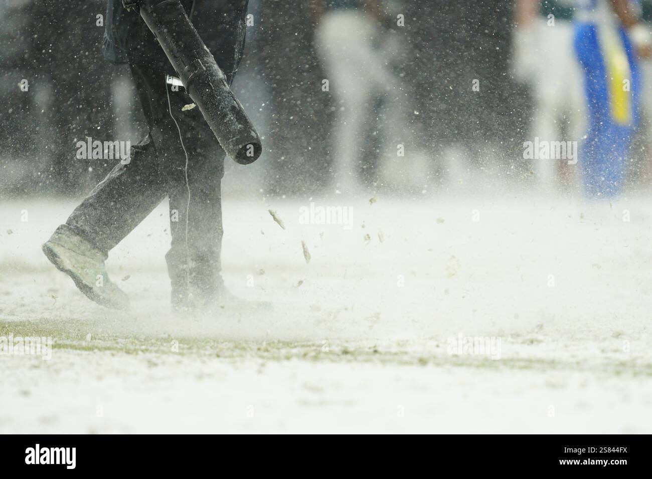 Crews clear snow during an NFL football NFC divisional playoff game ...