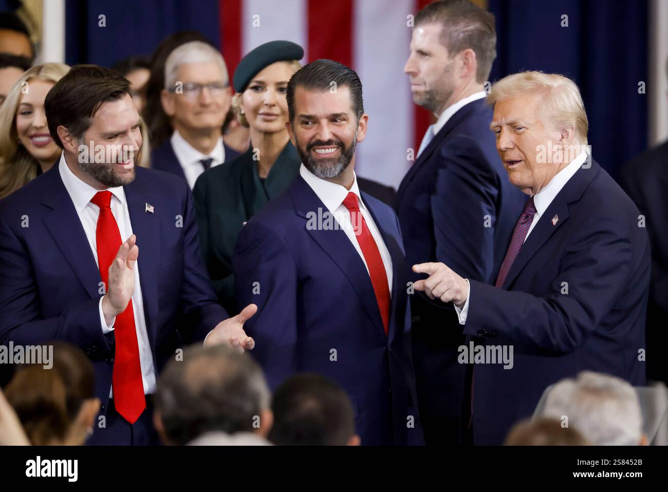 US President Donald Trump (R) with his son Donald Trump Jr. (C) and US ...
