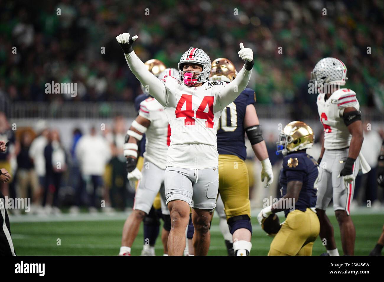 Ohio State defensive end JT Tuimoloau celebrates after tackling Notre ...