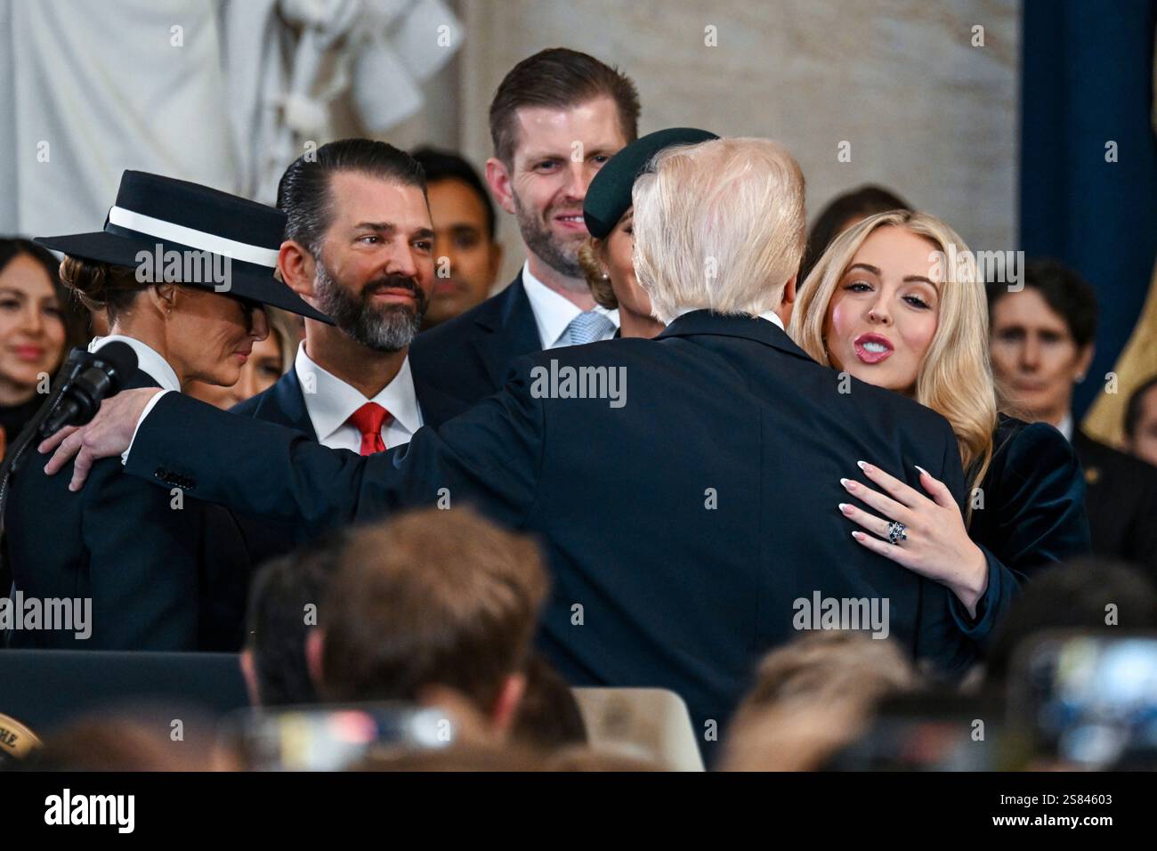 President Donald Trump, center, hugs his family including Melania Trump ...