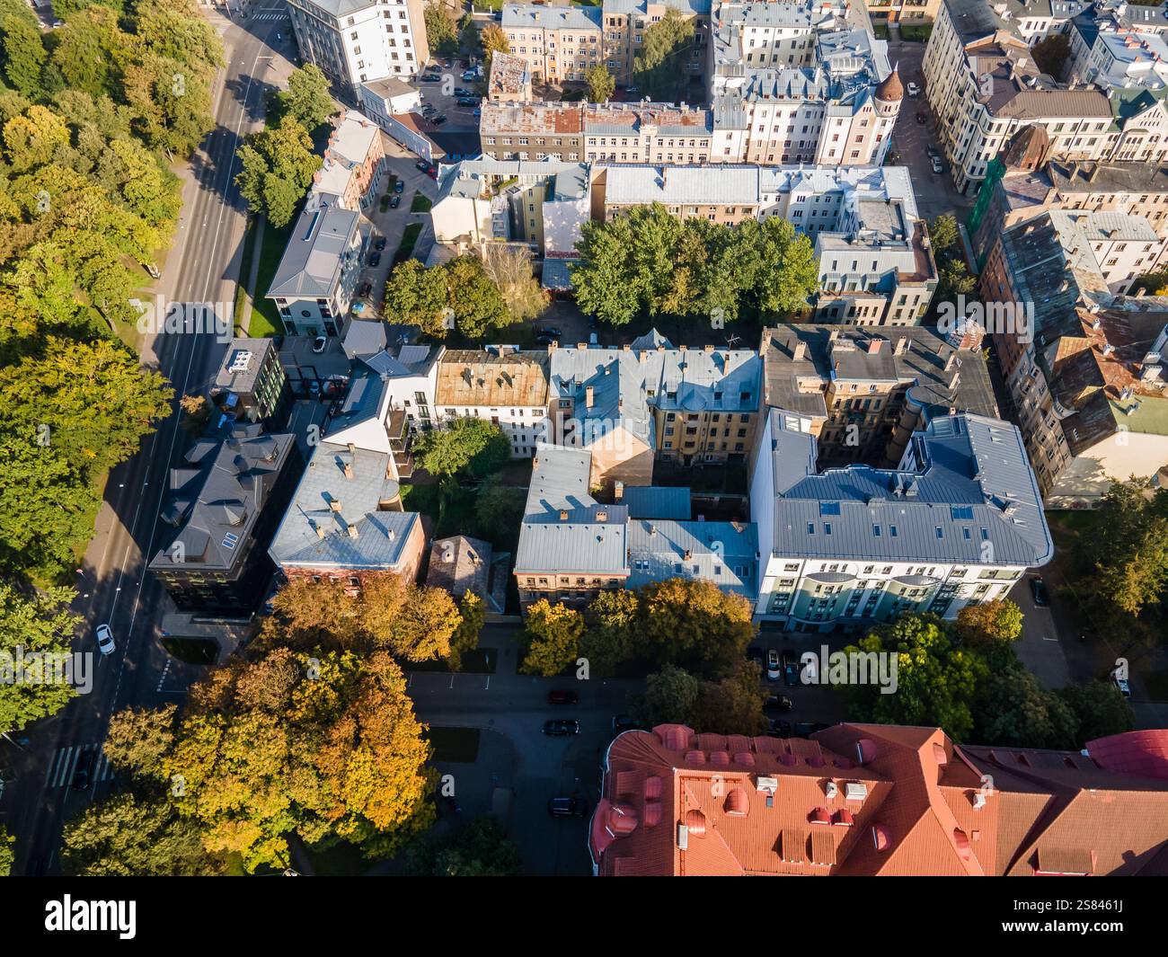 Compact urban area with grid like streets, light facades, pitched roofs ...