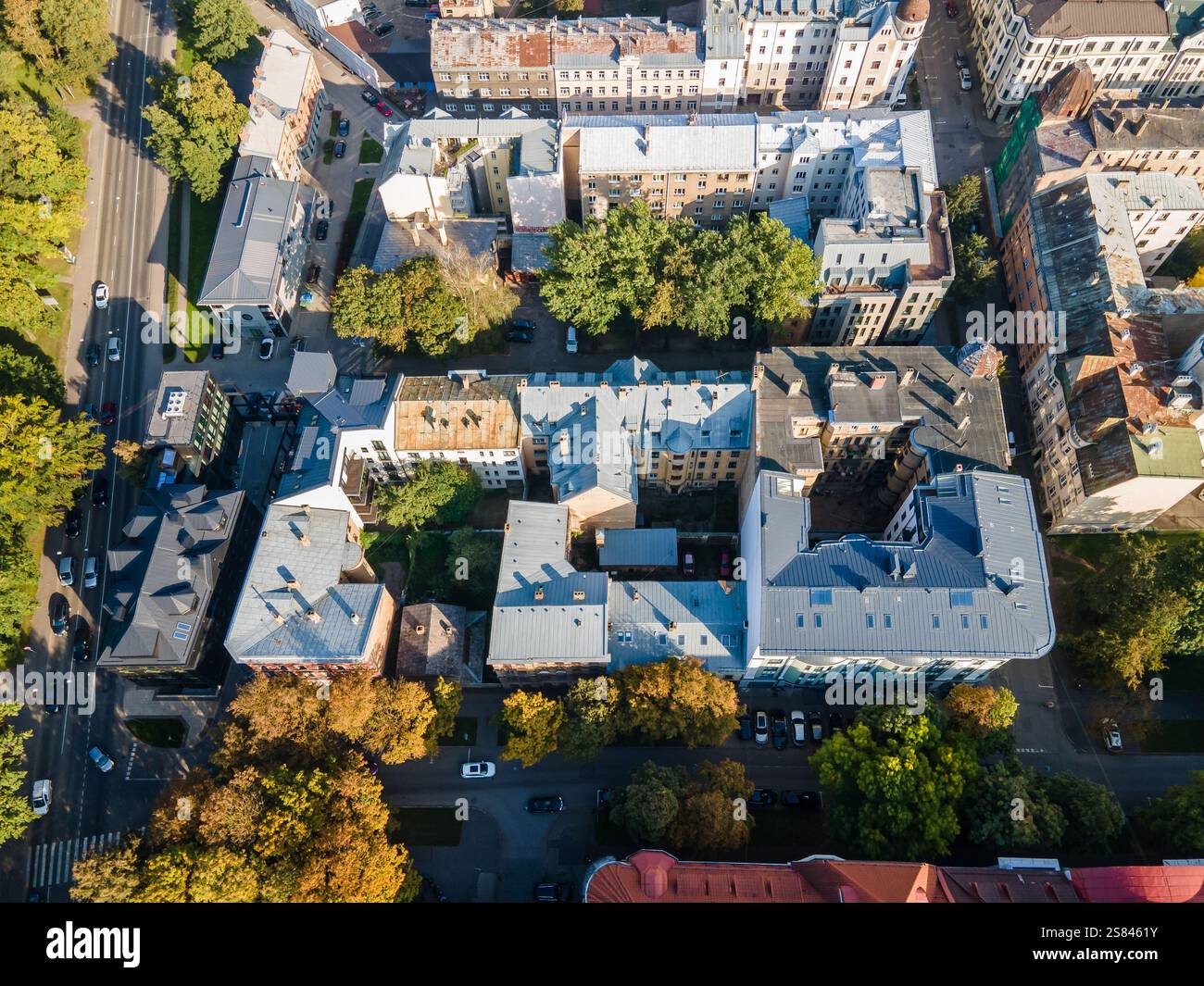 Compact urban area featuring light colored facades, sloped roofs ...