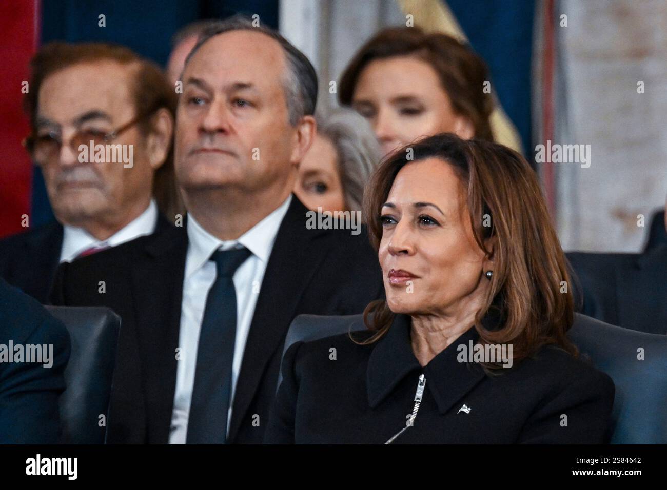 Former Vice President Kamala Harris, right, and Doug Emhoff listen ...