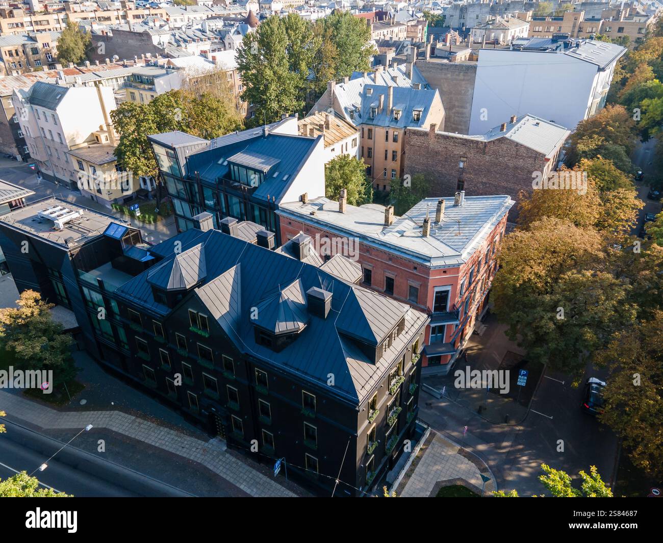 Cityscape featuring a black building with angular roof, red brick ...