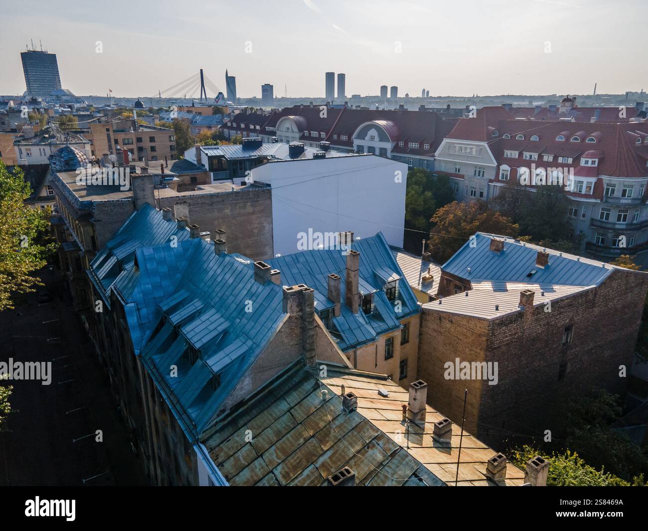 Urban scene featuring blue roofed historic buildings, a curved ...