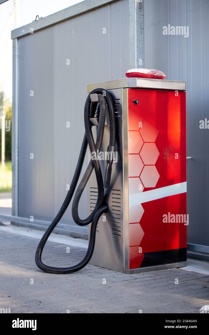 Outdoor vacuum station with hexagonal front panel design, coiled hoses ...