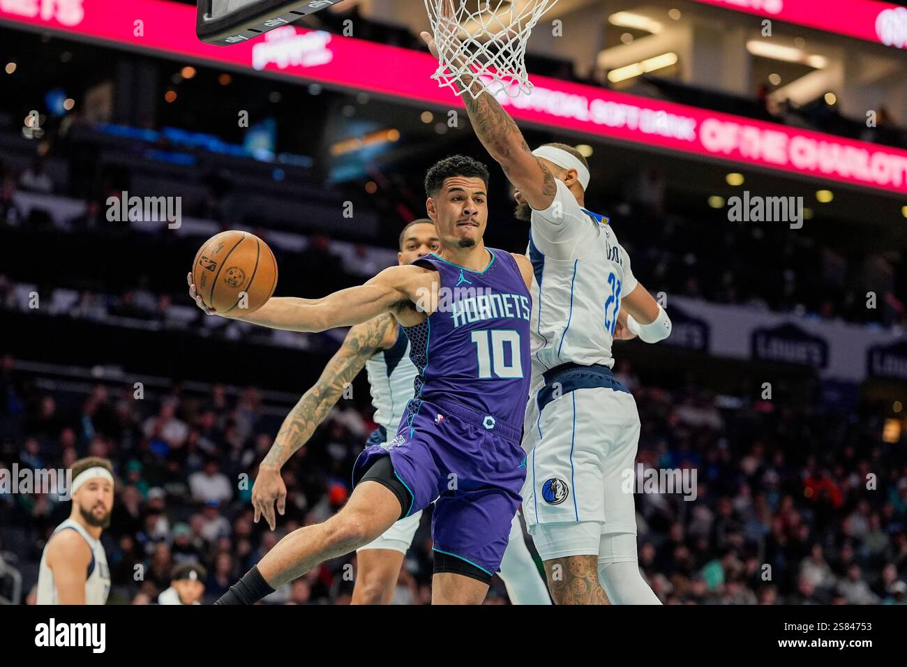 Charlotte Hornets guard Josh Green (10) passes under the basket around ...