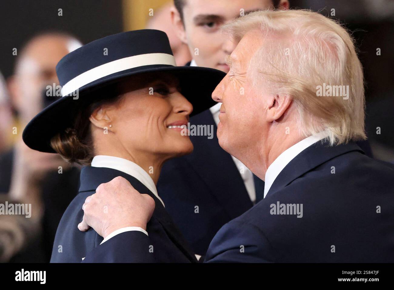 President Donald Trump, right, reaches to kiss first lady Melania Trump ...