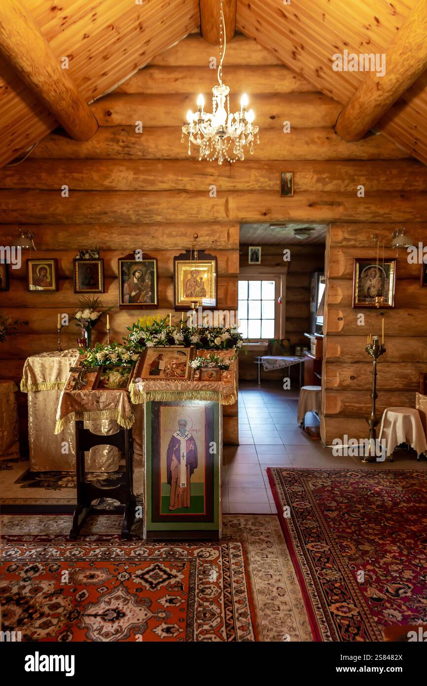 Wooden chapel interior featuring log walls, a vaulted ceiling, a ...