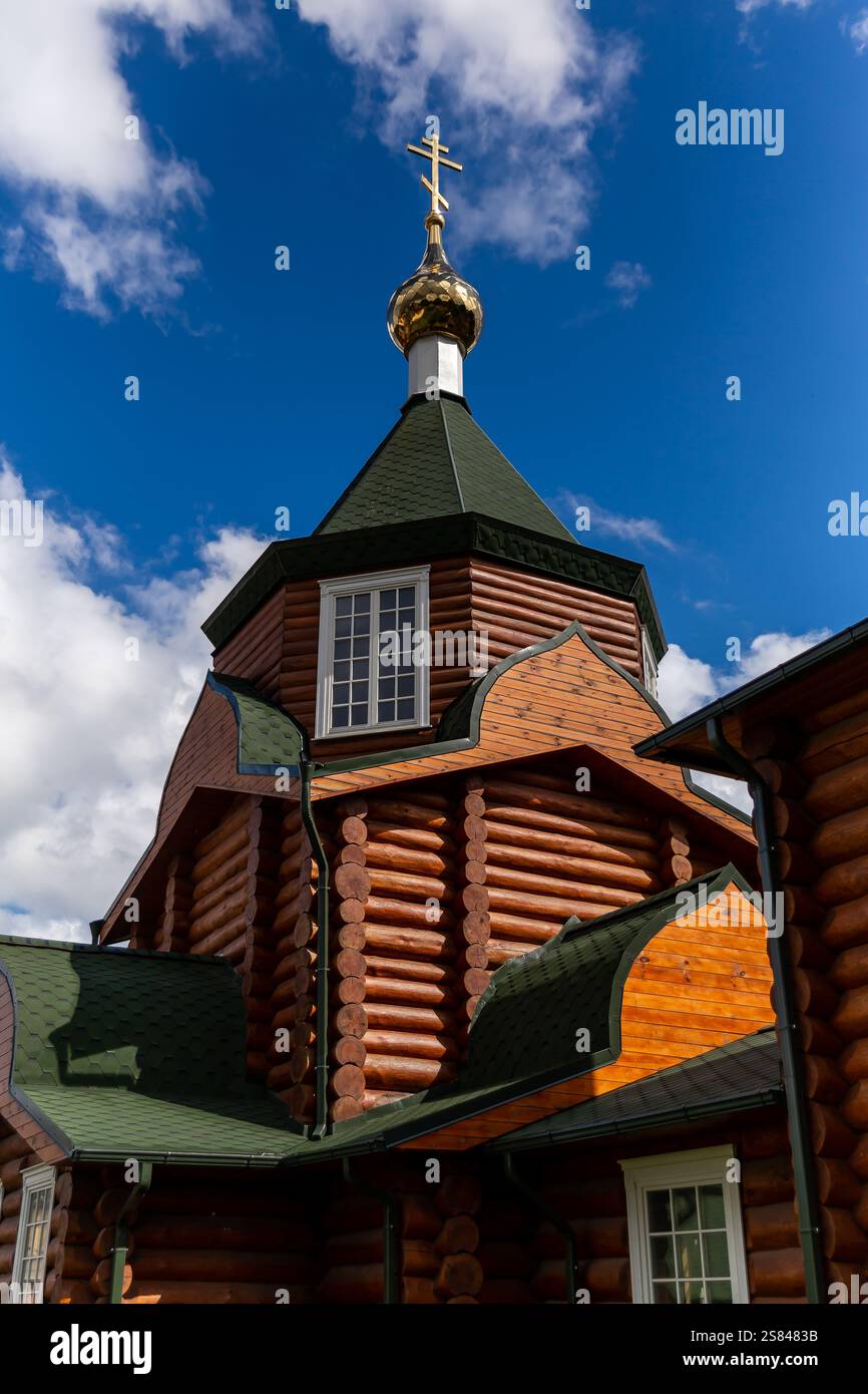 Wooden church with log construction, green roof, and golden onion ...