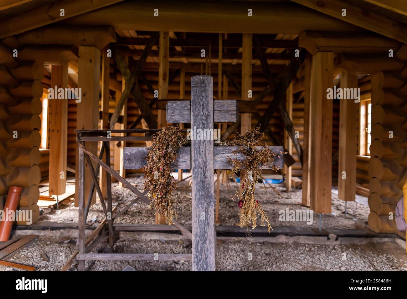 Wooden structure under construction with exposed beams, log walls, and ...