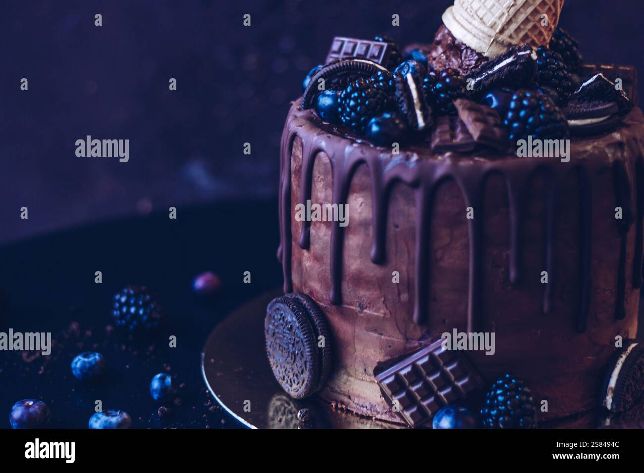 Rich chocolate cake with glossy drip design, topped with blackberries ...