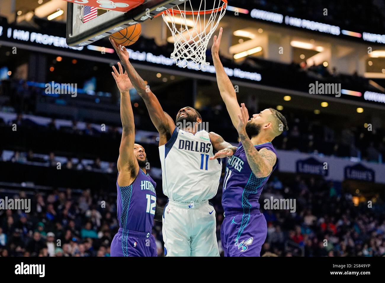 Dallas Mavericks guard Kyrie Irving (11) shoots a layup defended by ...