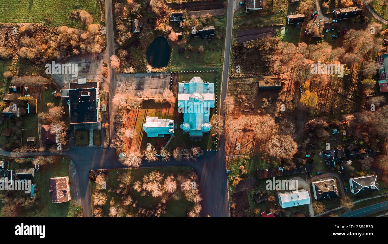 Aerial perspective of a village featuring a blue roofed building ...