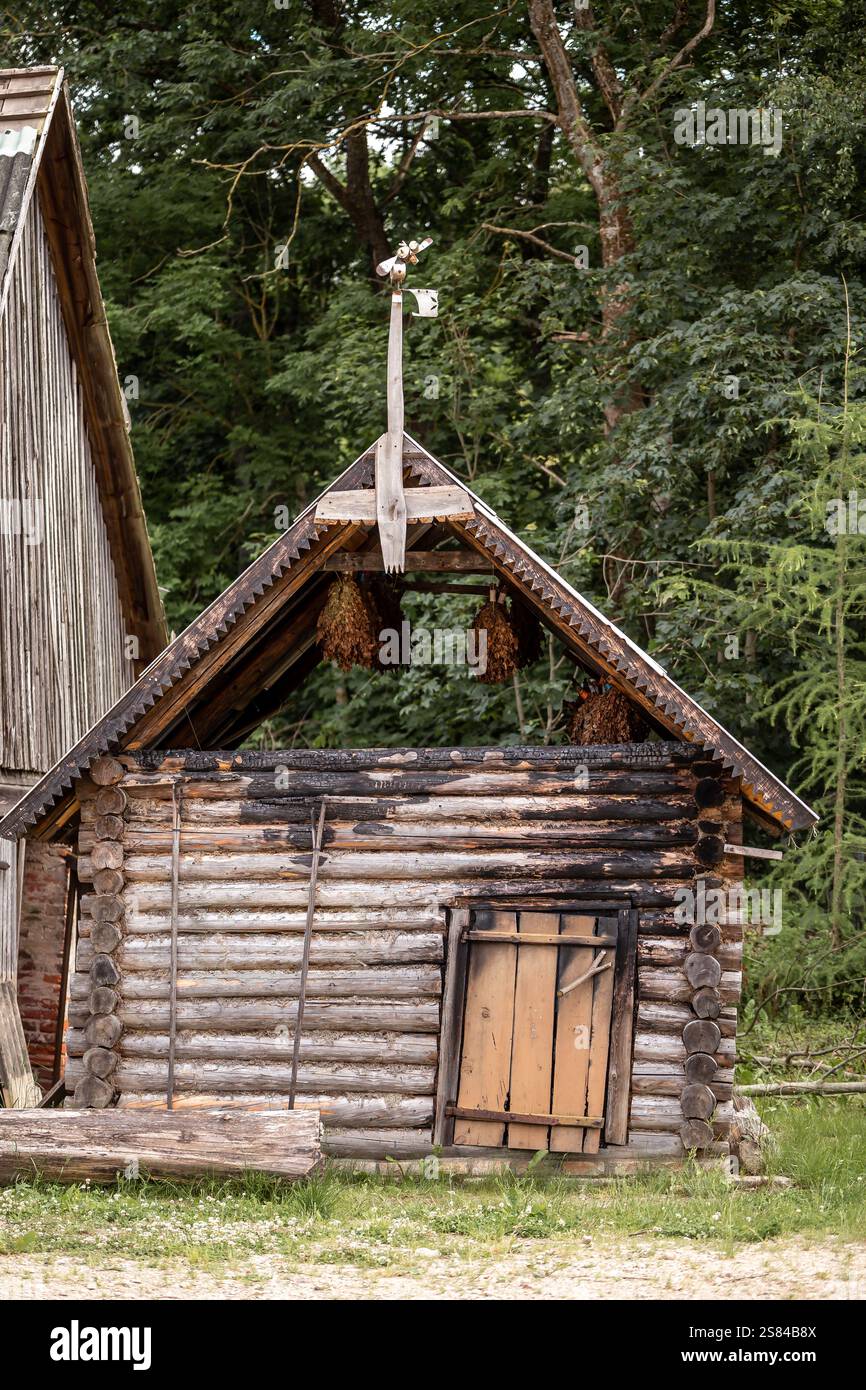 A small wooden log structure with a pitched roof, decorative edging ...