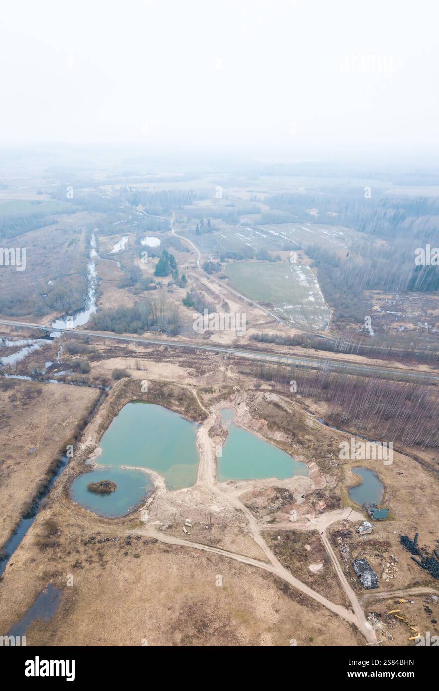Aerial perspective of a rural mining area featuring small ponds, dirt ...