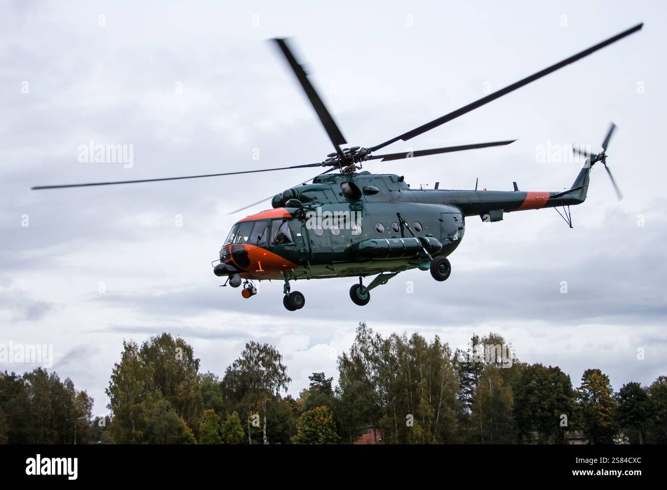 Military style helicopter SAR with green and orange design flies above ...