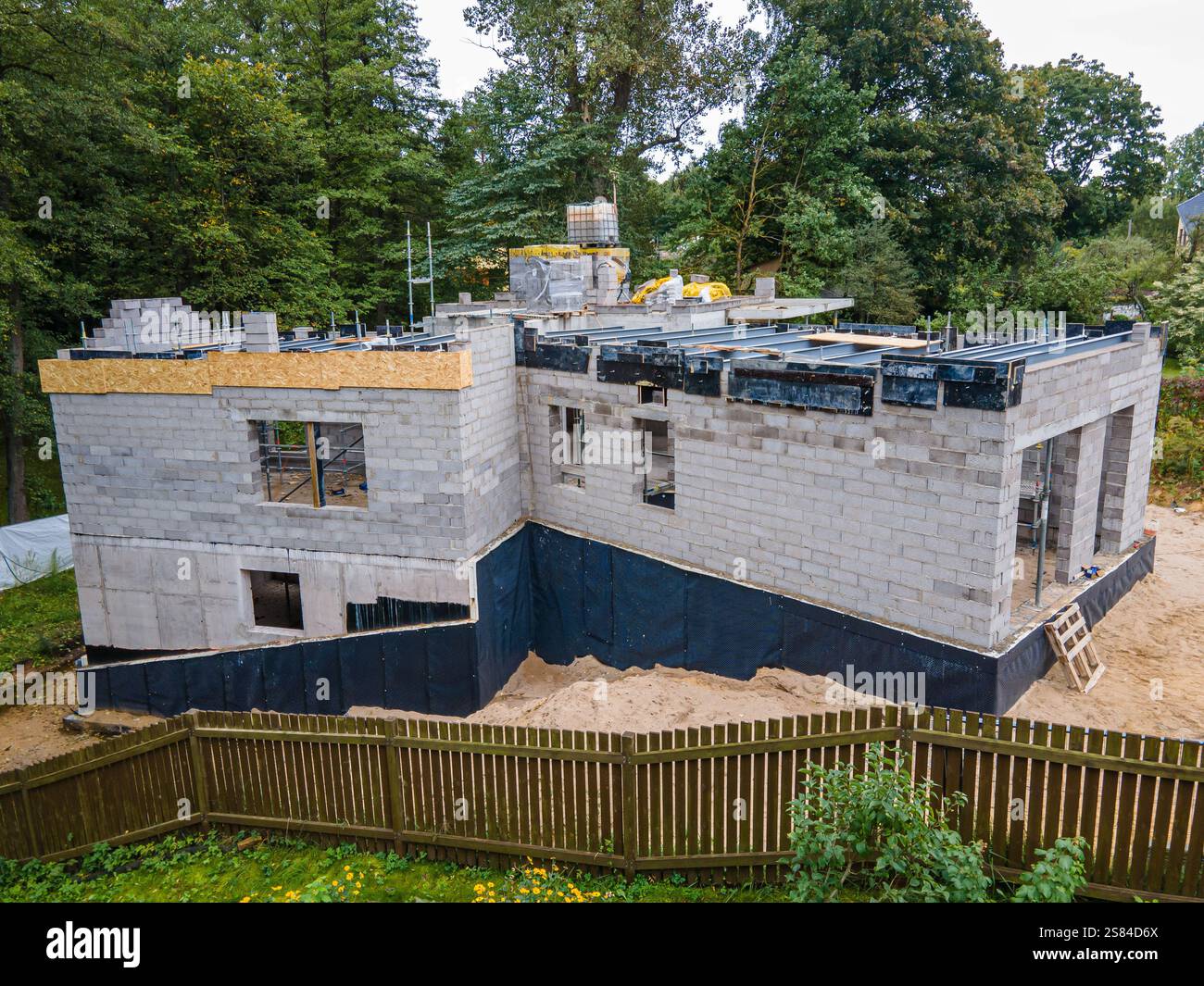 A two story concrete building under construction with scaffolding ...