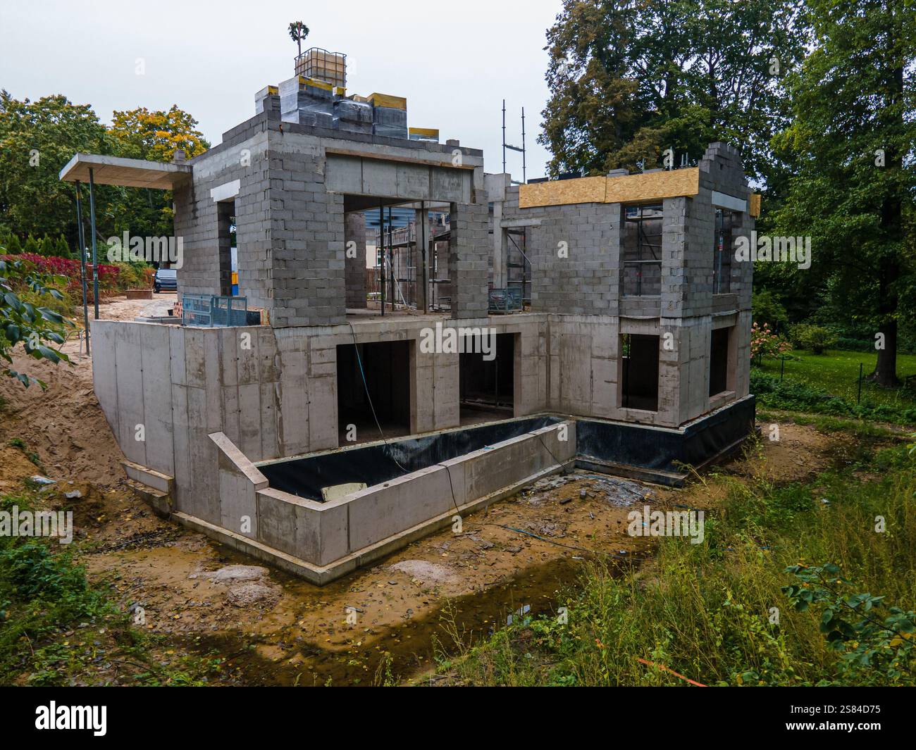 Modern building under construction with cinder block walls, scaffolding ...