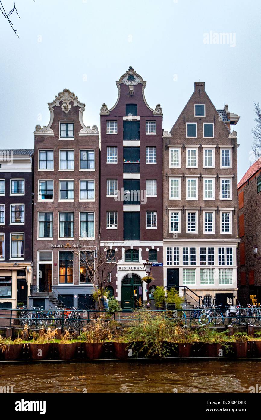 An iconic view of traditional Dutch facades by the canal in Amsterdam ...