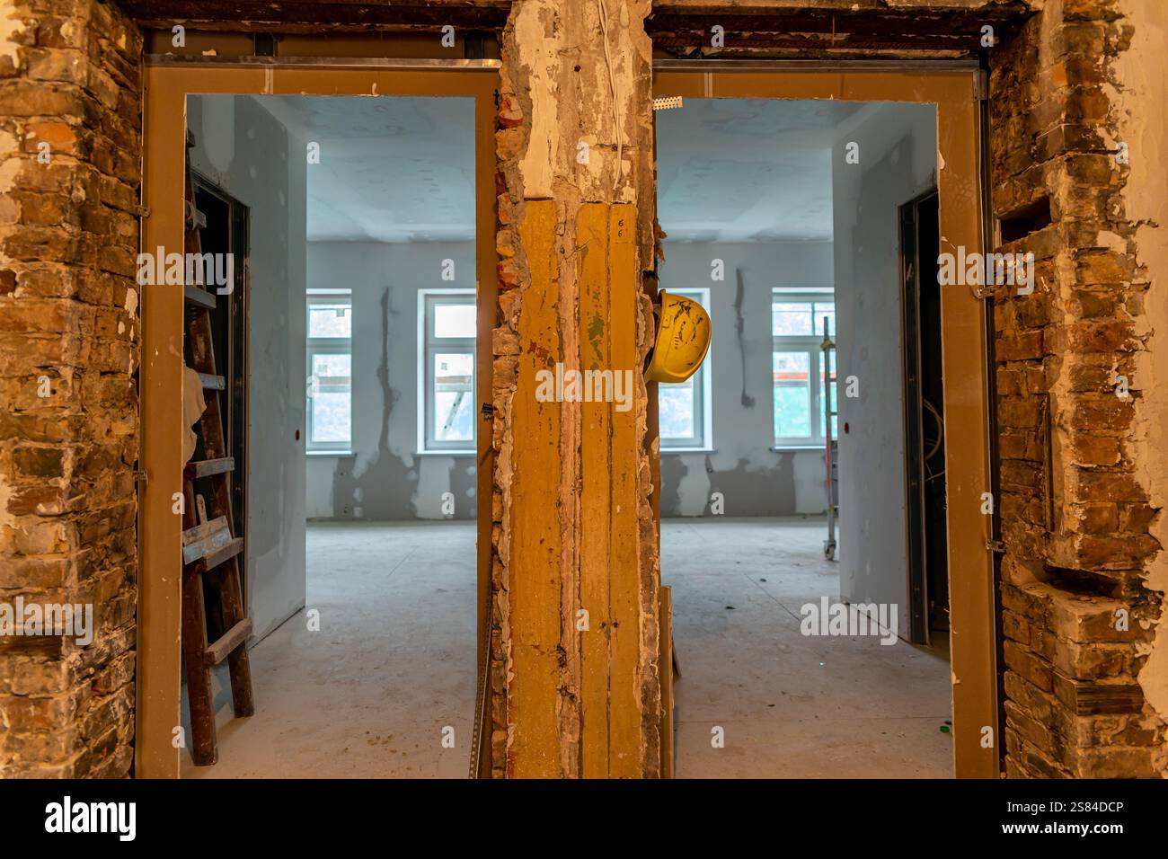 An urban building interior under renovation, featuring exposed brick, a ...
