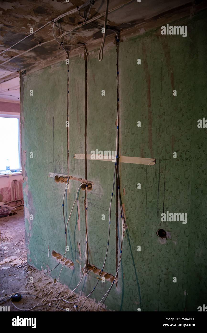 Interior under renovation featuring exposed wiring on a green wall ...