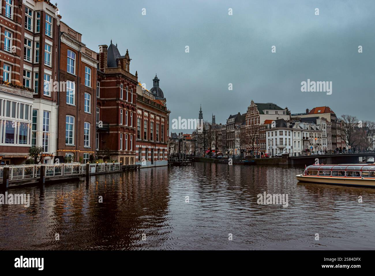 A stunning view of Amsterdam's historic canal lined with elegant brick ...