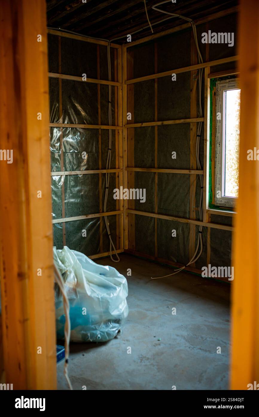 A small room under construction features exposed wooden framing ...