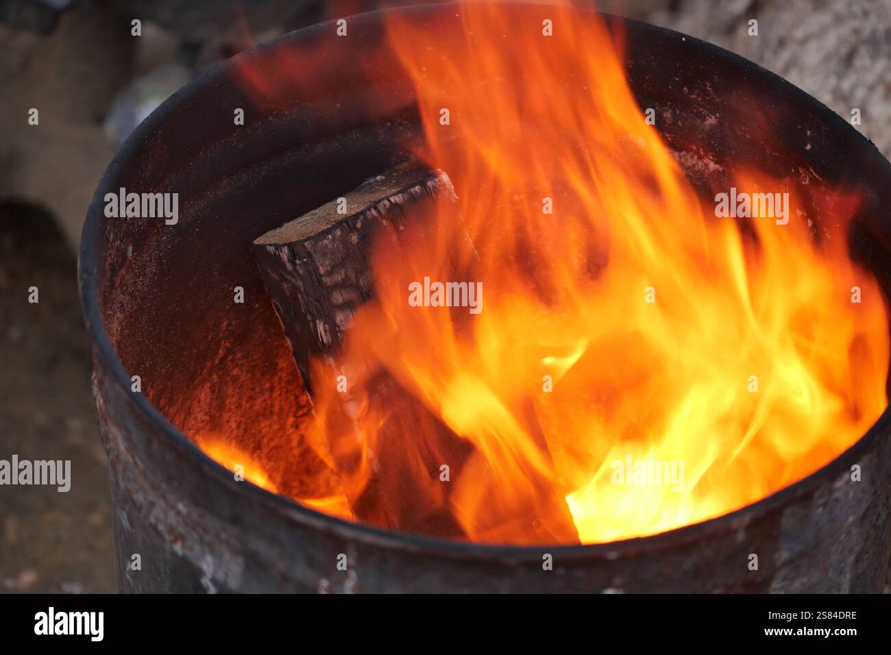 Flames Engulfing an Abandoned Piece of Wood Inside a Metal Barrel Stock ...
