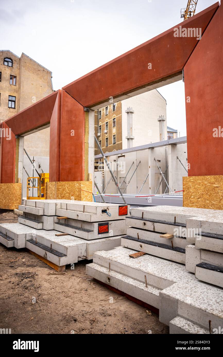 Construction site featuring red brown structural frames, concrete slabs ...