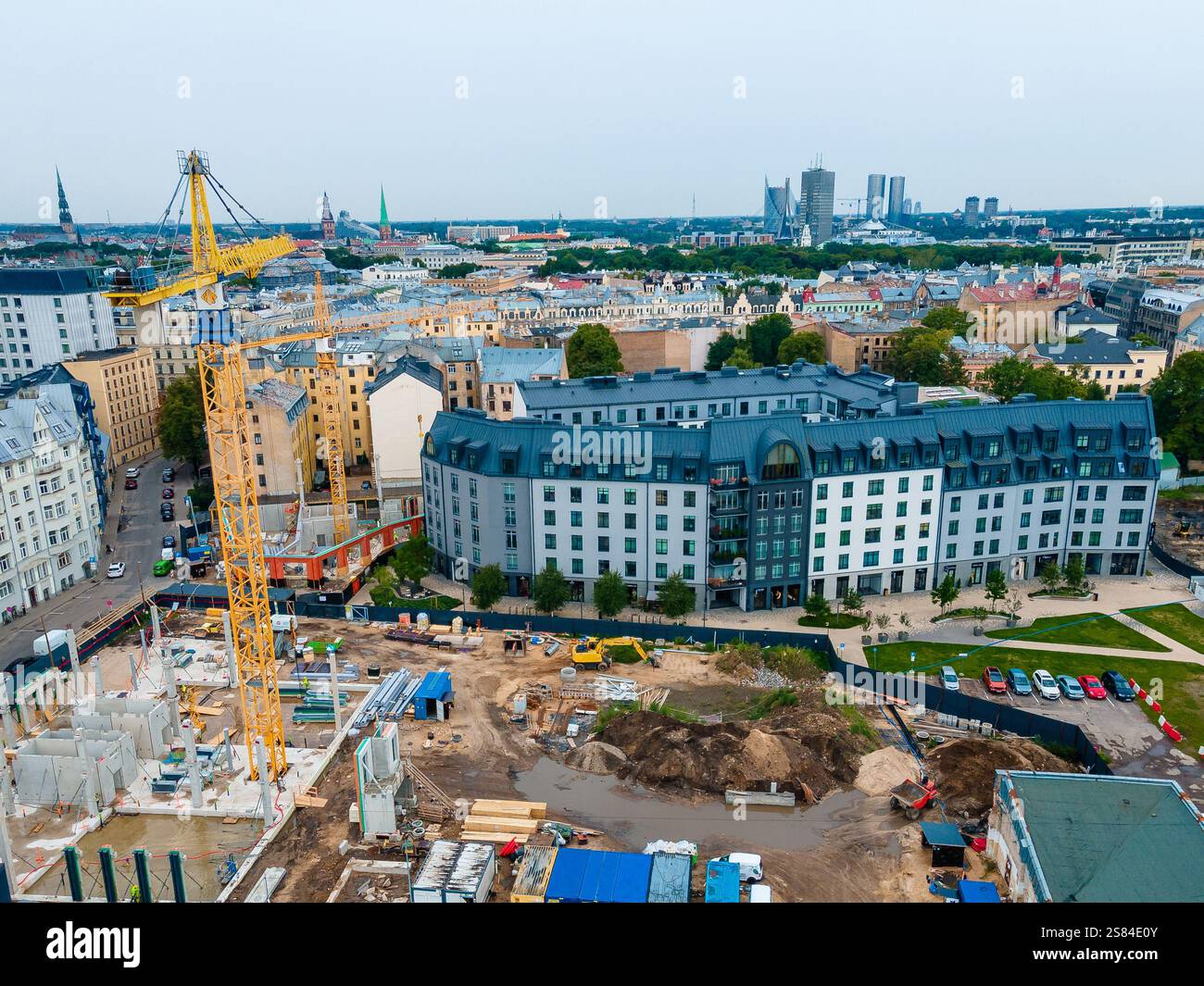 Construction site with a yellow crane and partially built structures ...