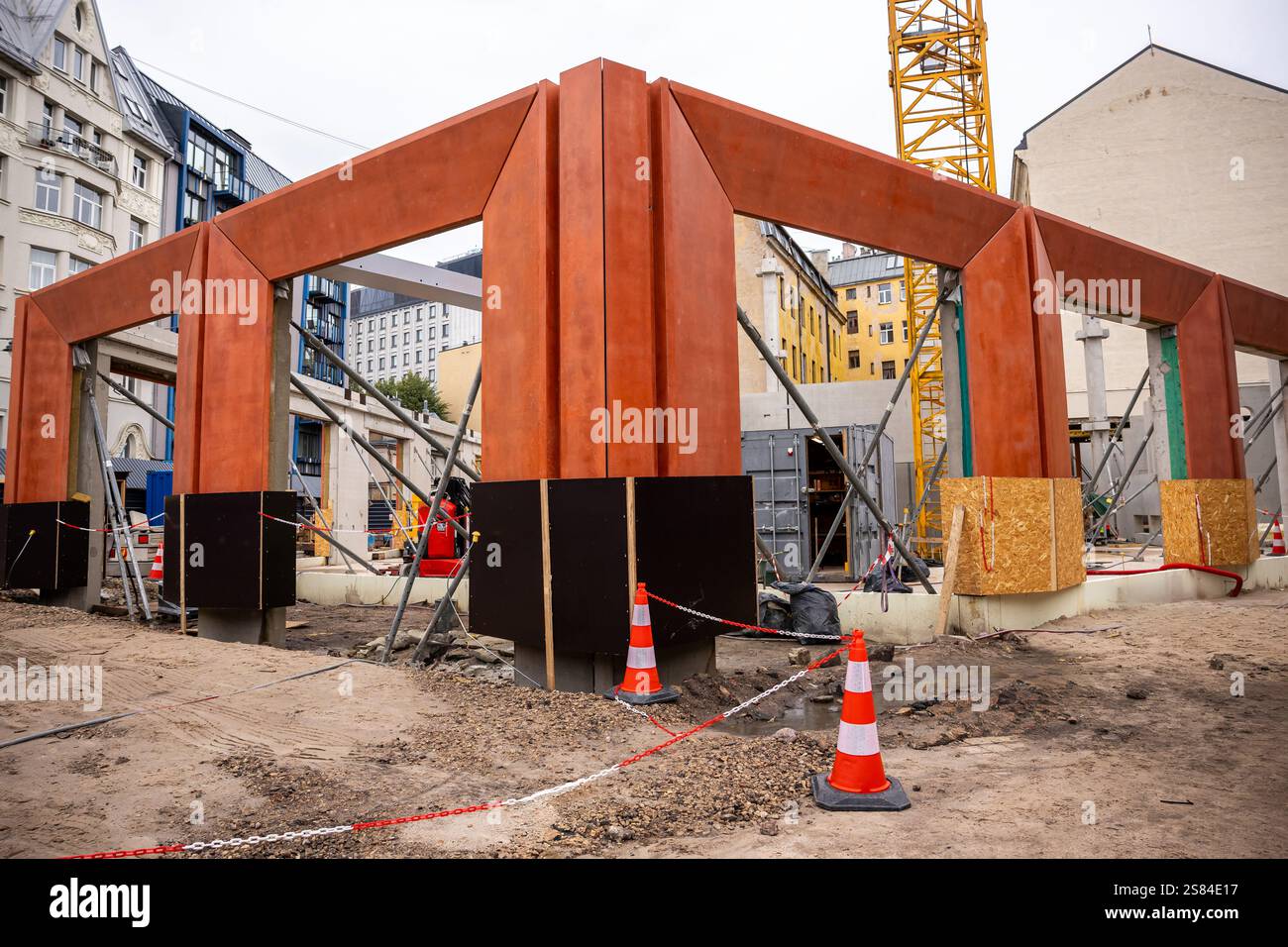 Construction site featuring a rust colored steel framework, safety ...