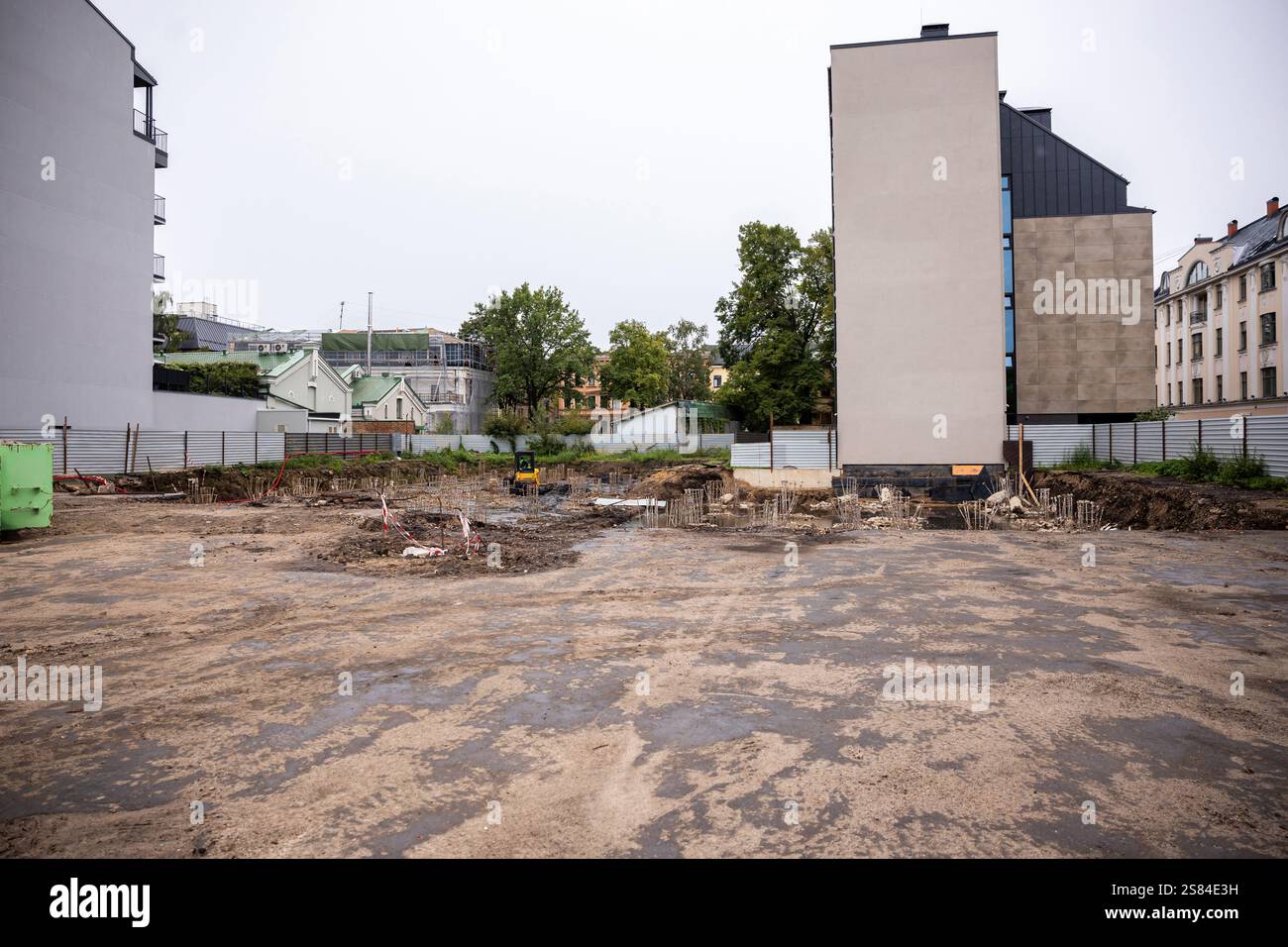 Excavated construction site surrounded by modern and traditional ...