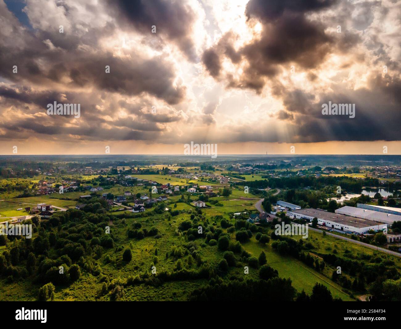 A countryside view featuring scattered houses, farmland, wooded areas ...