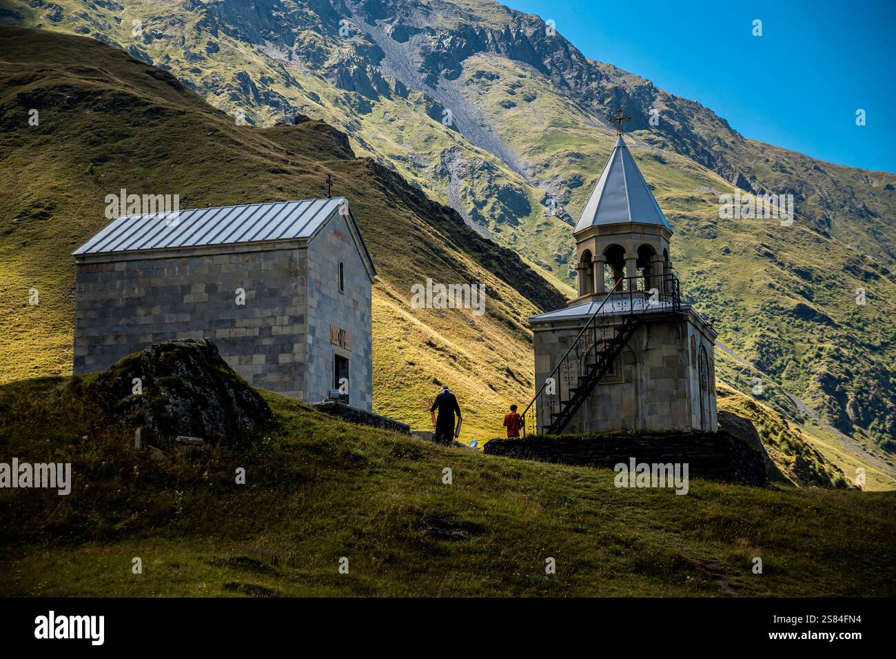 Two stone structures, including a church with a bell tower, sit on a ...