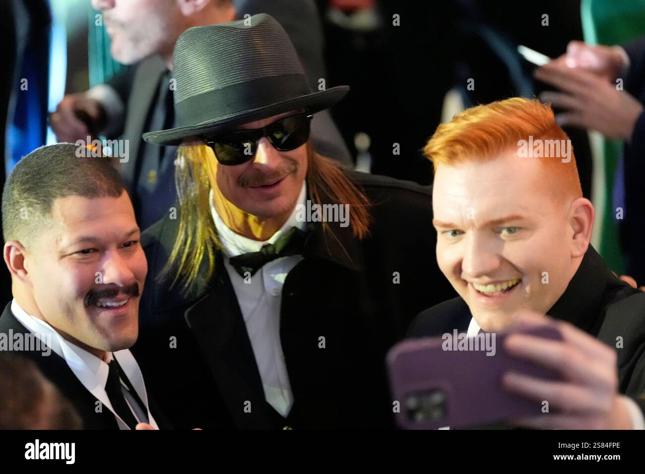Kid rock, center, poses with attendees at the Commander in Chief Ball ...