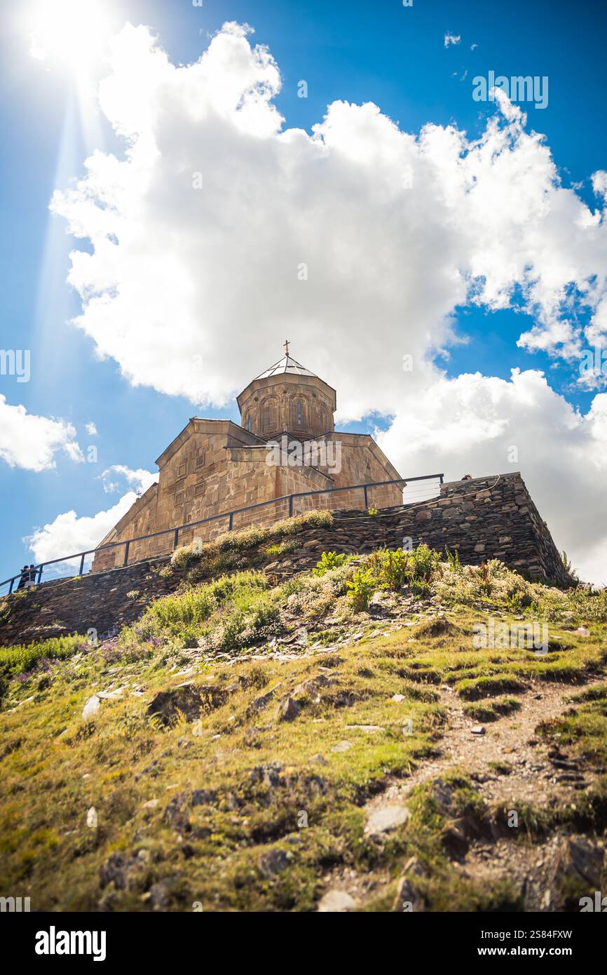 Historic stone church with cross topped dome on a hill, surrounded by ...