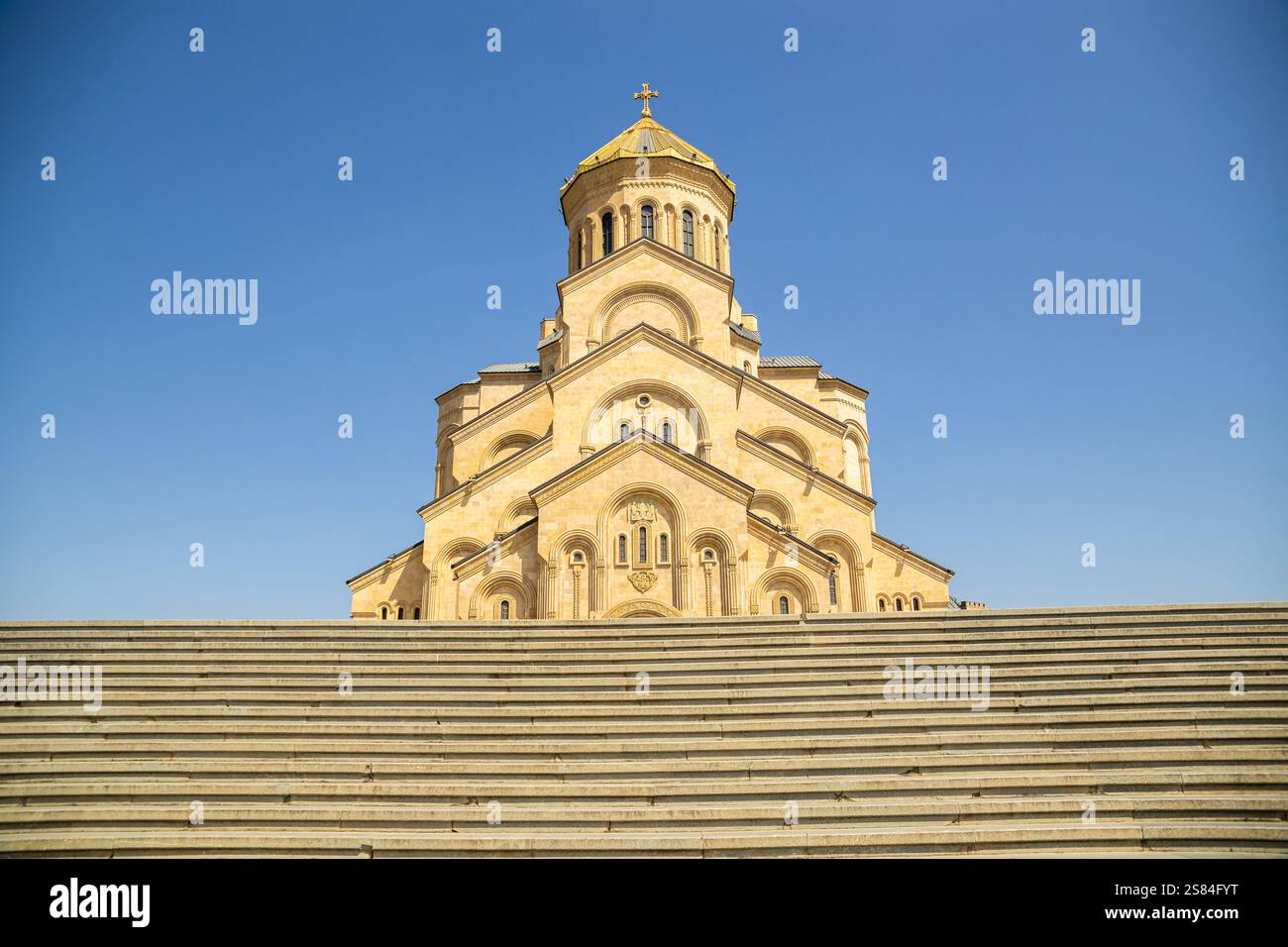 The Holy Trinity Cathedral of Tbilisi in Georgia features a golden dome, intricate stonework ...