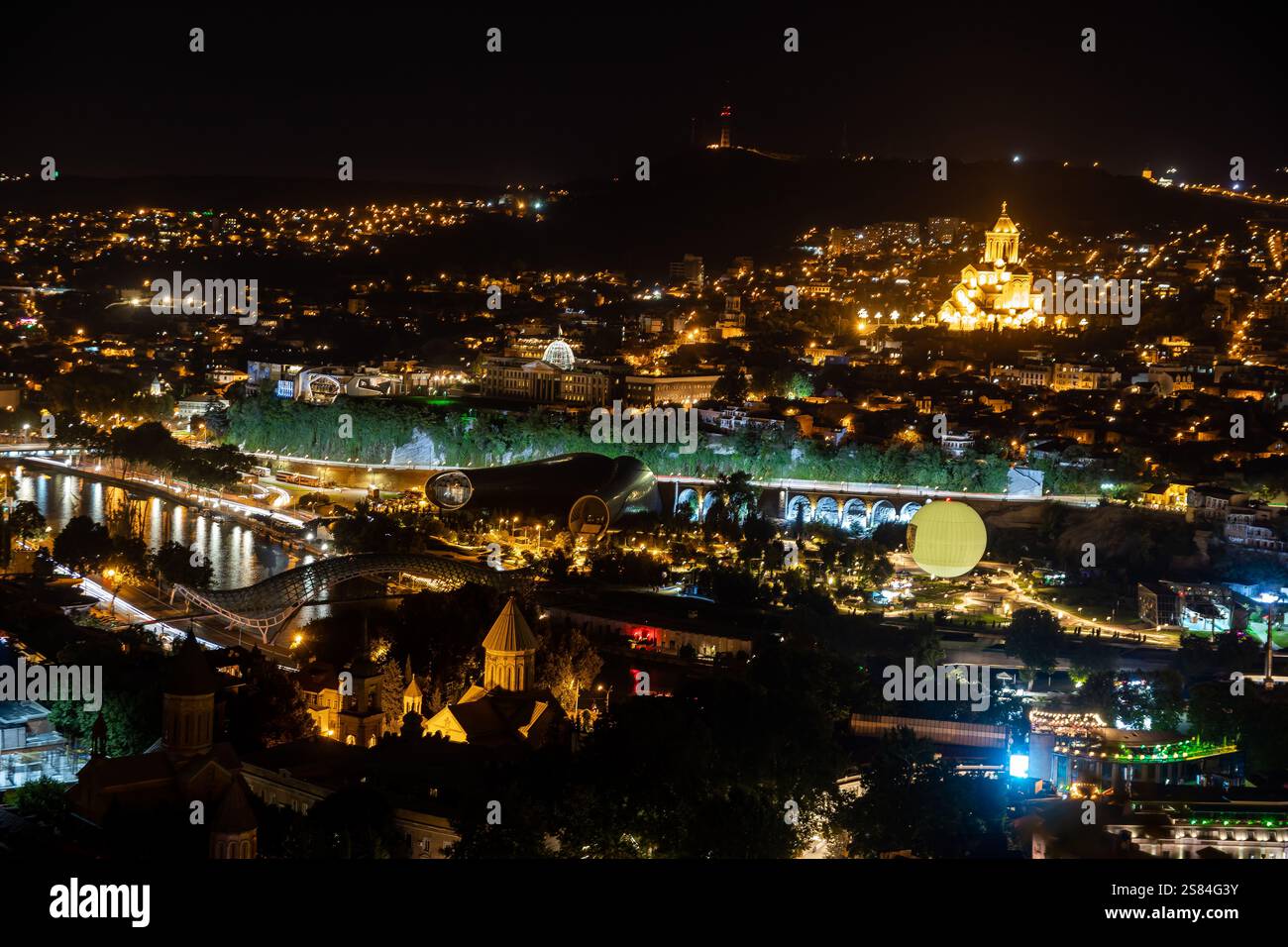 Tbilisi at night features the illuminated Holy Trinity Cathedral, the ...
