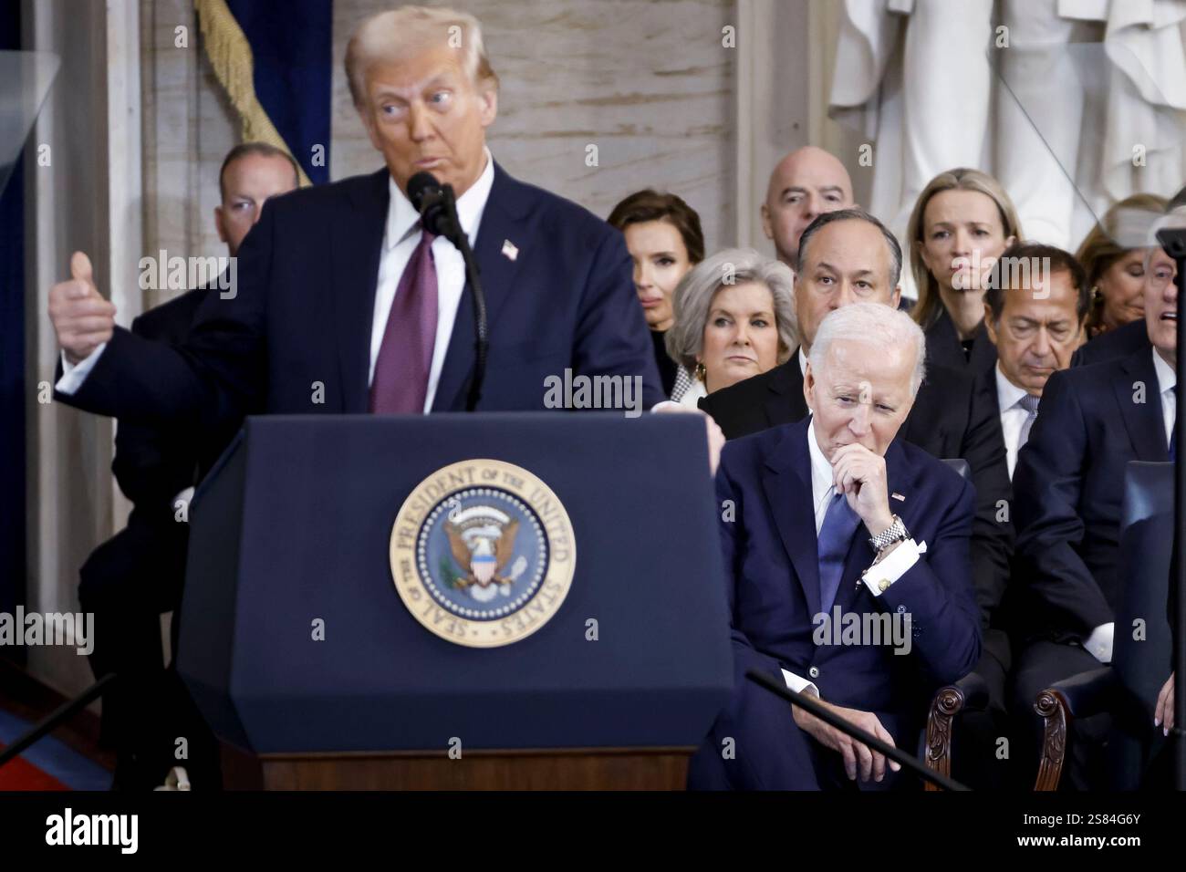 Former US President Joe Biden (R) listens as US President Donald Trump ...