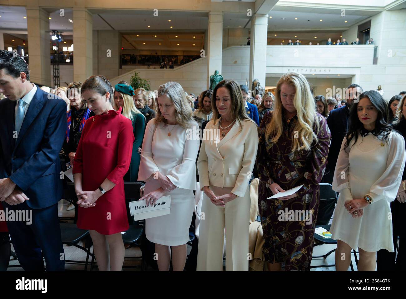 Guests listen to the invocation speech in an overflow room for ...