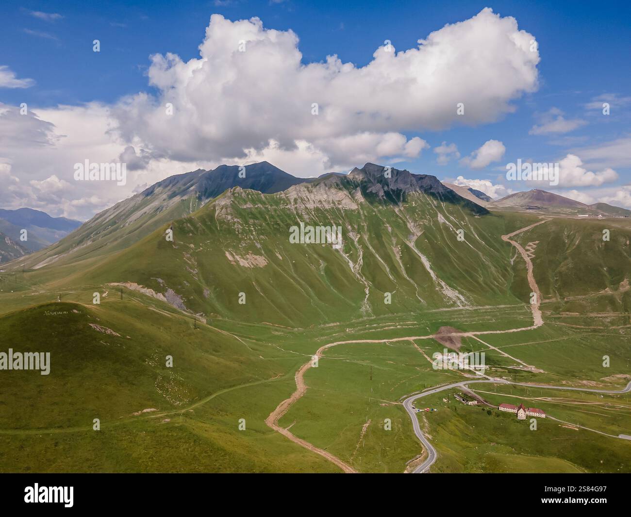 Vast green mountains with trails and roads, part of the Caucasus in ...