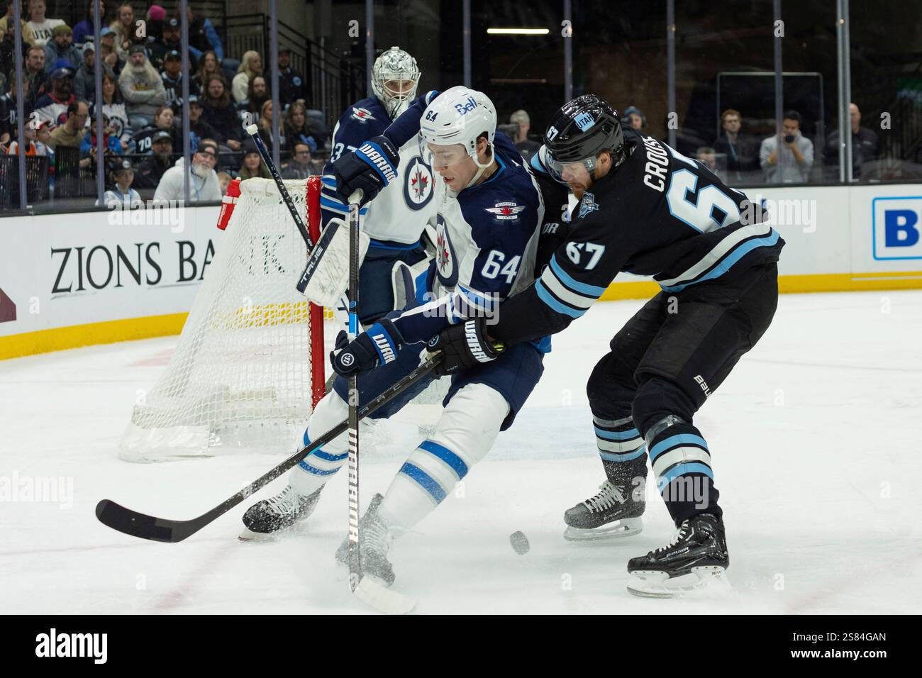 Winnipeg Jets defenseman Logan Stanley (64) fights for the puck against ...
