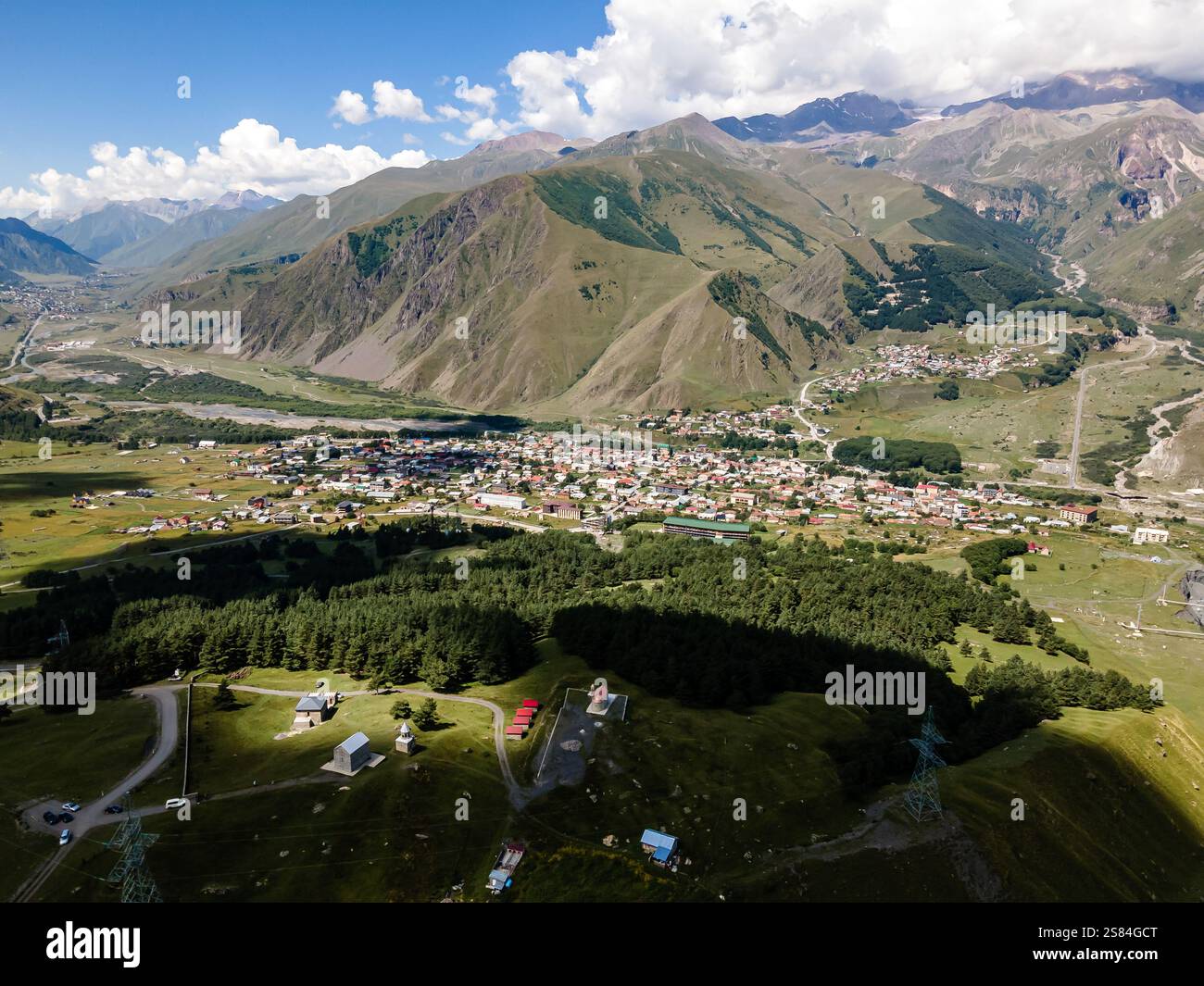 A rural town in Georgia lies in a valley with red and white rooftops ...