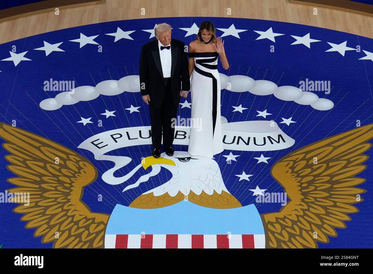 First lady Melania Trump waves as she stands with President Donald ...