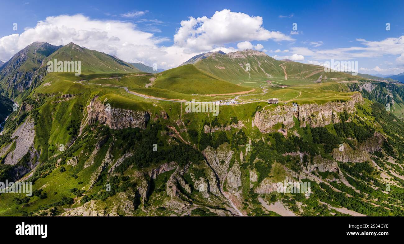 Dramatic terrain in Georgia with steep cliffs, rolling green hills, a ...