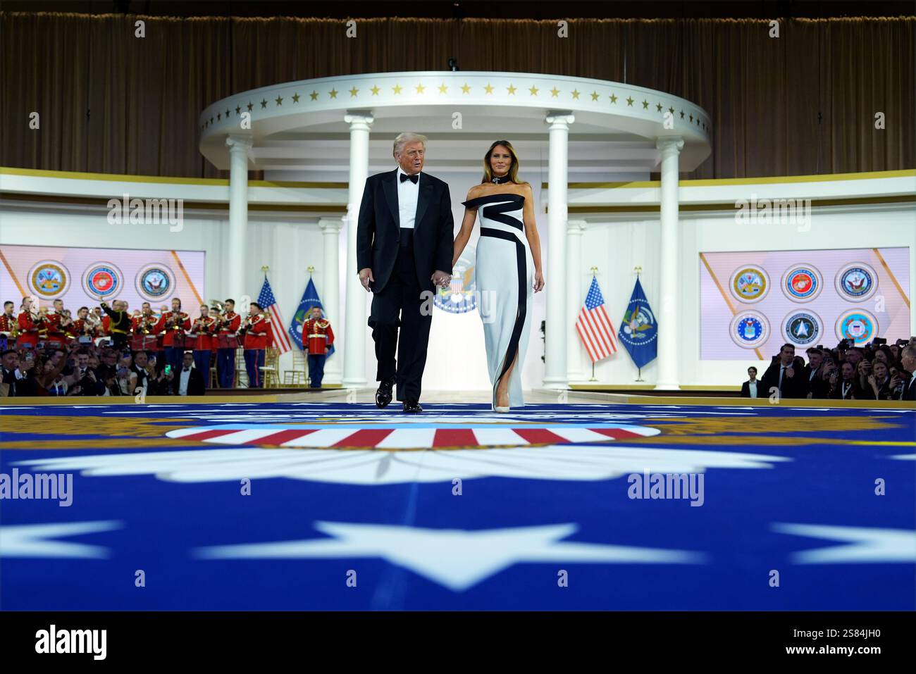 President Donald Trump and first lady Melania Trump arrive on stage to dance at the Commander in ...