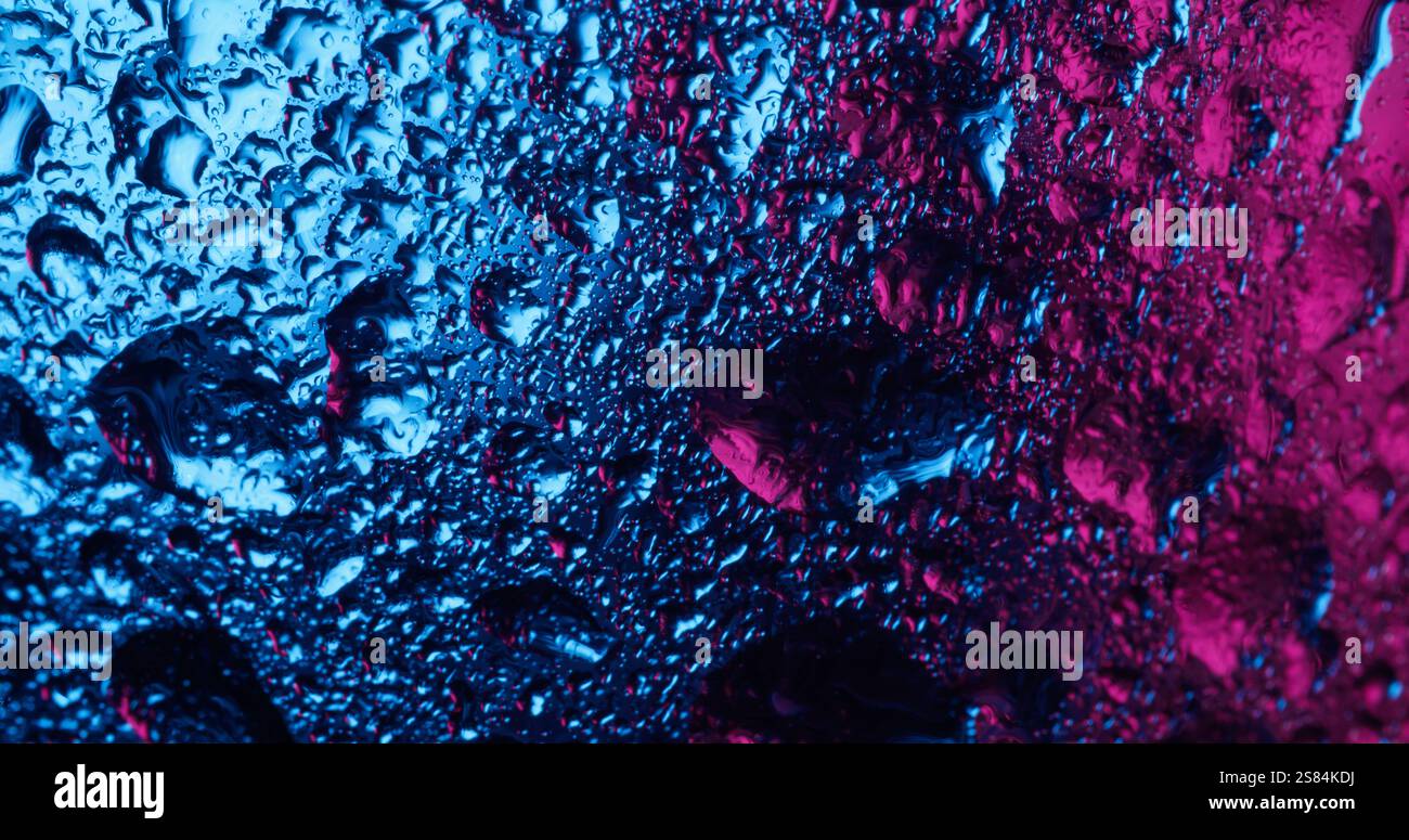 Wet shimmer. Multicolored drops. Condensate rain flow on metal foil ...