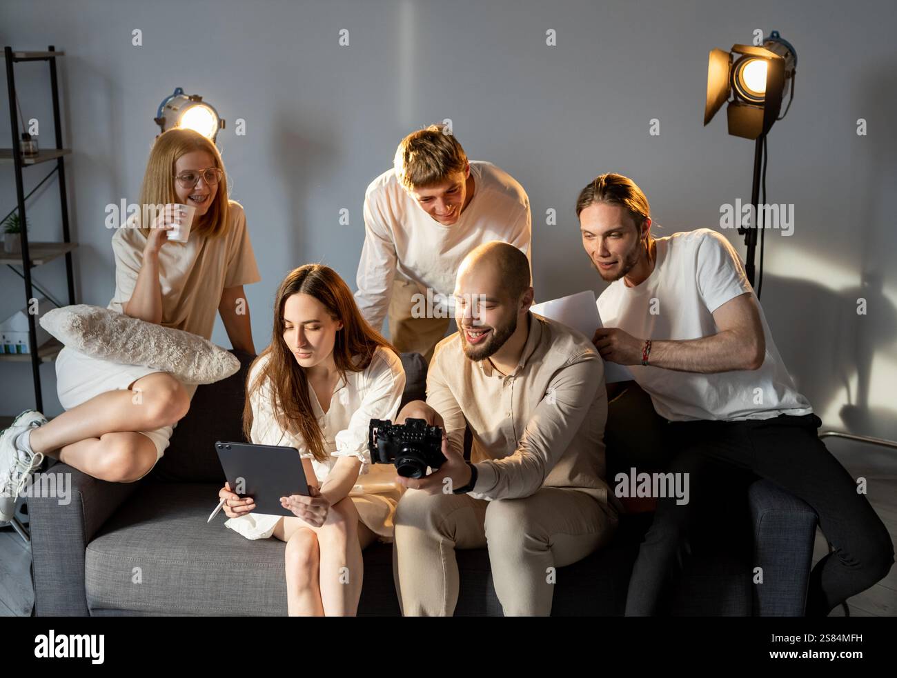 Team project. Photo studio. Cheerful people in light room having ...